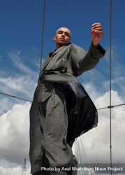 Stylish Young Man In Belted Gray Coat Blowing In The Wind Against A ...