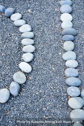 Small River Rocks In Curved Lines On Top Of Small Pebbles In Garden ...