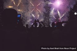 Back of audience taking pictures of stage with fireworks - Premium ...