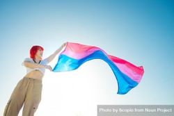 Woman with red hair waving a colorful flag - Free Photo (5RzkA5) - Noun ...
