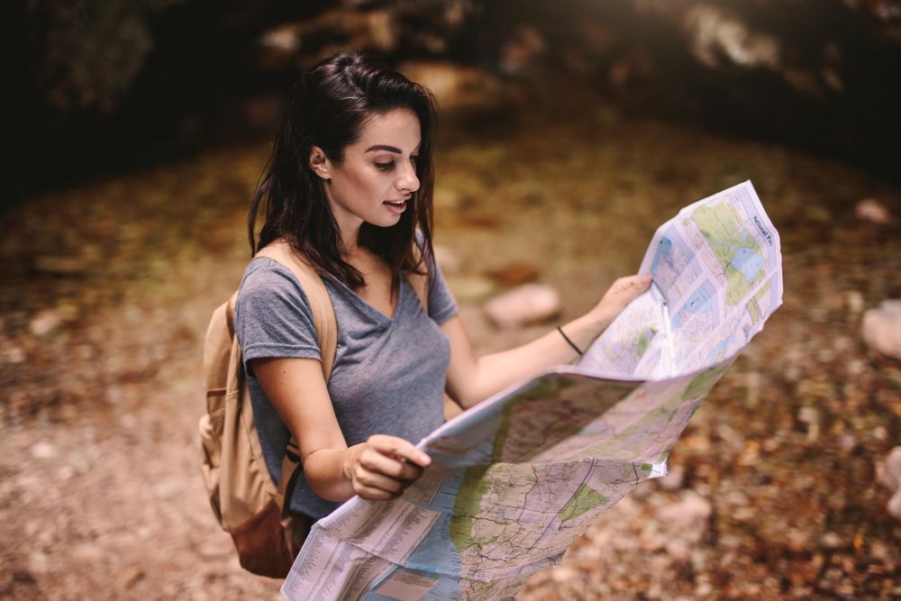 Female hiker in forest reading a map - Premium Photo (0gdz75) - Noun ...