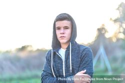 Teenage Male In Hoodie Standing In Field Looking At Camera With Arms Crossed - Free Photo ...