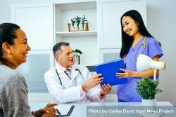 Happy nurse handing doctor patient’s file in office - Premium Photo ...