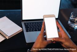 Anonymous man browsing smartphone near laptop - Free Photo (4AzOm6 ...