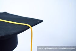 Side view of graduation cap in plain studio with space for text ...