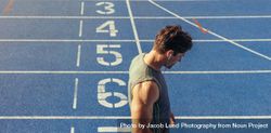 Sprinter Standing On Running Track Looking Down With Copy Space - Free ...