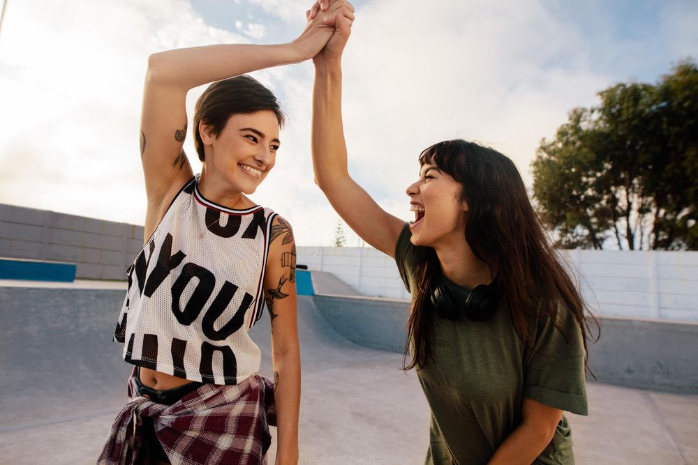 Two excited female friends high fiving at skate park - Premium Photo ...