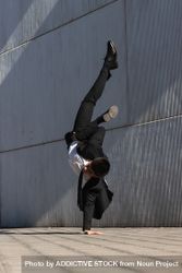 Asian businessman performing breakdance handstand on street - Free ...