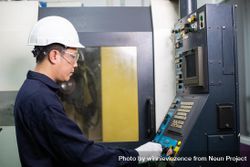 Man Operating Machinery In Construction Site In Safety Helmet And ...