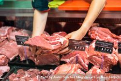 Butcher taking meat from display - Free Photo (5olMz4) - Noun Project