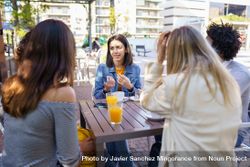 Woman Explaining Something To Her Friends At An Outside Table - Free ...