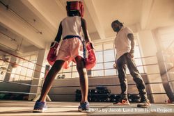 Boxing Student Training With Her Coach Inside A Boxing Ring Wearing ...