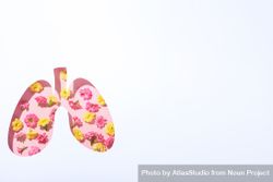Lung shape cut out of paper with bronchus and pink and yellow flowers ...
