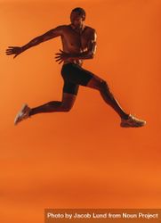 Male Fitness Model Jumping In Mid-Air And Twisting To His Side - Free ...