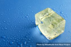 Top View Of Large Rectangular Ice Cube With Lemon Slice On Blue Table ...