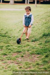 Little boy pushing a wheel at a park - Premium Photo (O48Zj0) - Noun ...