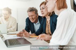 Three Colleagues Engage In A Collaborative Discussion, Observing The ...